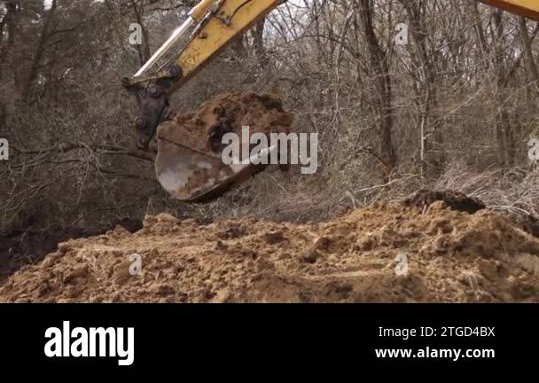 Working with backhoe by digging ground at construction site. Excavator ...