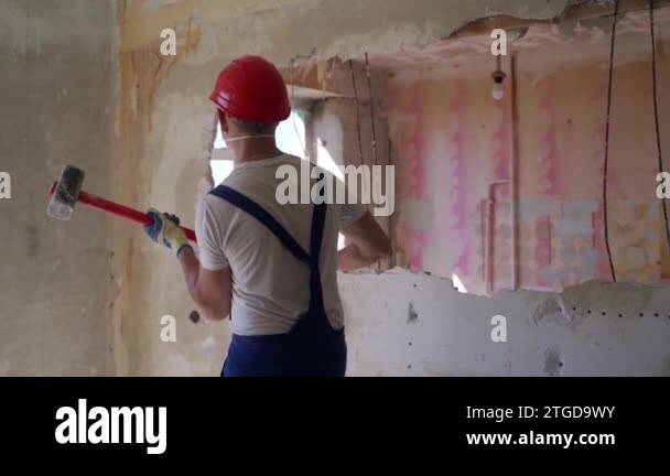 Contractor wrecks wall with sledgehammer making hole for rearrangement ...