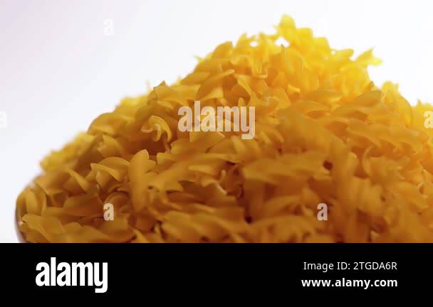 Uncooked Fusilli Pasta Heap Rotating against White Background. Fat and ...