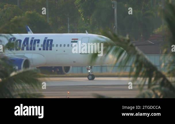 PHUKET, THAILAND - NOVEMBER 27, 2019: Side view through palm trees of ...