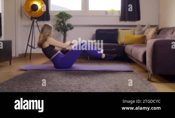 Girl making russian twist at home. Effective abdominal training made by ...