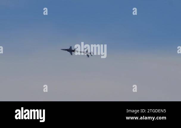 Pair of combat aircrafts in flight at high speed in a very close ...