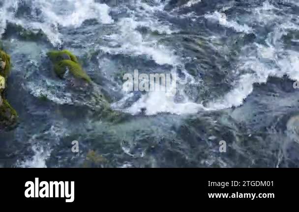 8K 7680x4320. Pure water stream running through stone boulders. Wild ...