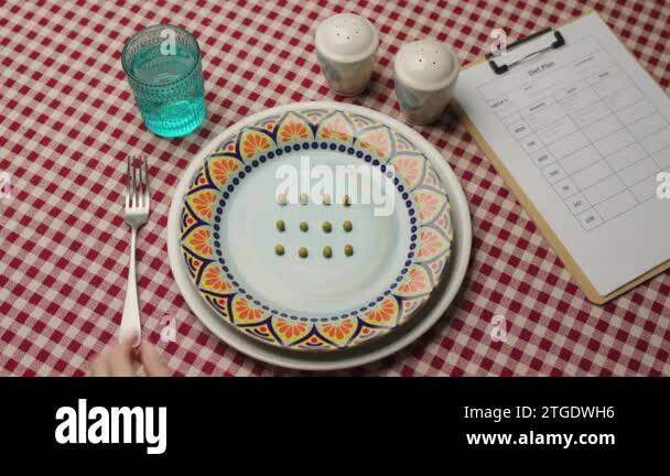 Diet Concept. Hands eating peas and writing diet plan, top view. 4K ...