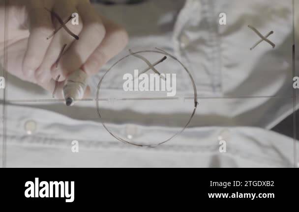 Soccer coach drawing soccer tactics on glass with black marker ...