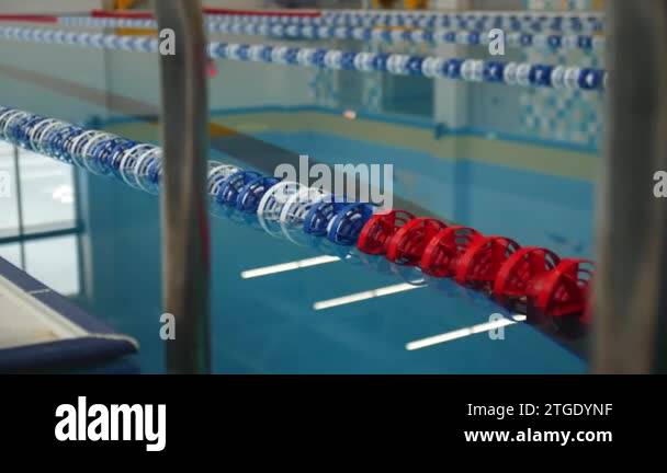 Plastic separator chain on swimming pool with fresh clear water in ...