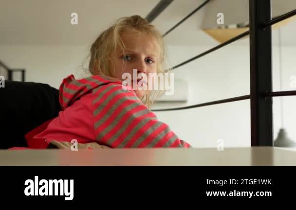A frustrated, sad girl looks at the camera and then turns away. Blond ...