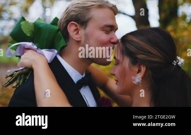 Lovely tender scene between newlyweds. Back view of Scandinavian groom ...