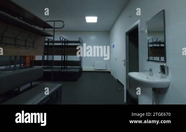 Empty locker room with benches and hangers near open door to public ...