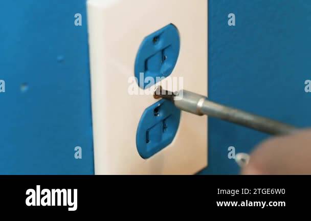 Installing a black socket housing on an old blue wall socket on a ...