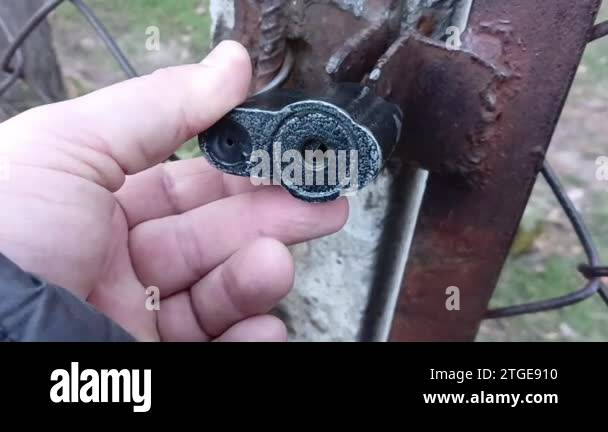 old padlock. lock in hand. The process of opening an old lock. old ...