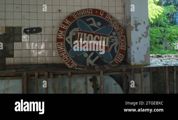 broken wall of the gym, where a large analog wall clock and a Soviet ...