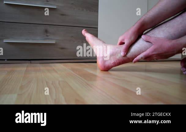 European man stretches achilles tendon after achilles tendon rupture ...