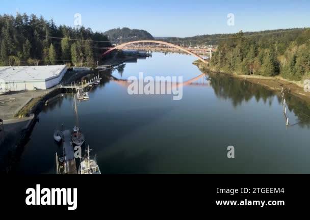 An aerial footage of Rainbow bridge with its reflection shown on the ...