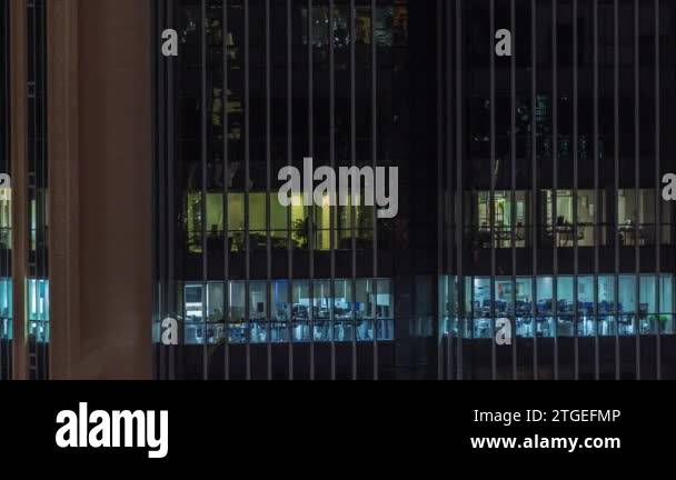 Windows lights in modern office buildings timelapse at night. Multi ...