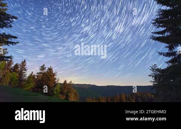Time lapse of comet-shaped star trails in the night sky. Stars move ...