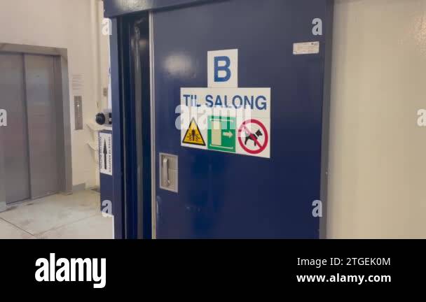 Pneumatic fire door opening on the car deck to the salong. Static shot ...
