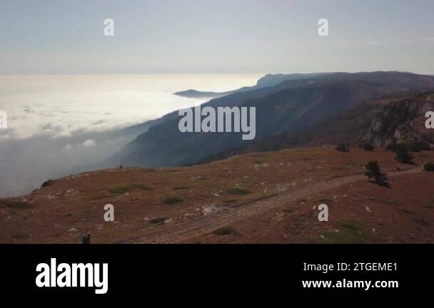 Aerial shooting from flying drone of hiking man walking on mountain ...