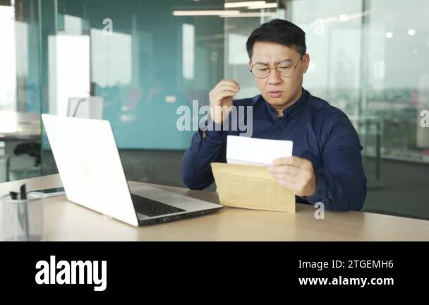 Frustrated asian businessman IT programmer with glasses receive open ...