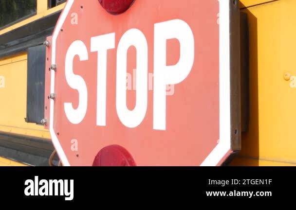 Red stop sign, yellow school bus in California, USA. Traffic warning on ...