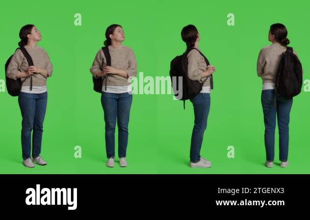 Casual girl carrying backpack and posing on studio background, having ...