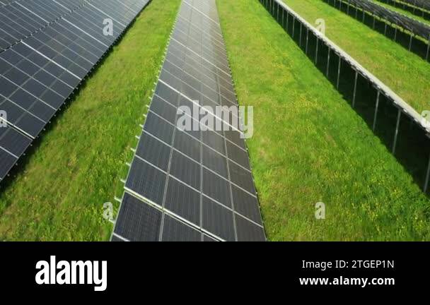 Modern sun panels built on lush green grass of rural field at eco ...