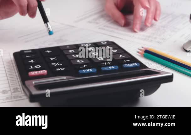 Financial data, analysis and calculation on a calculator in the office ...