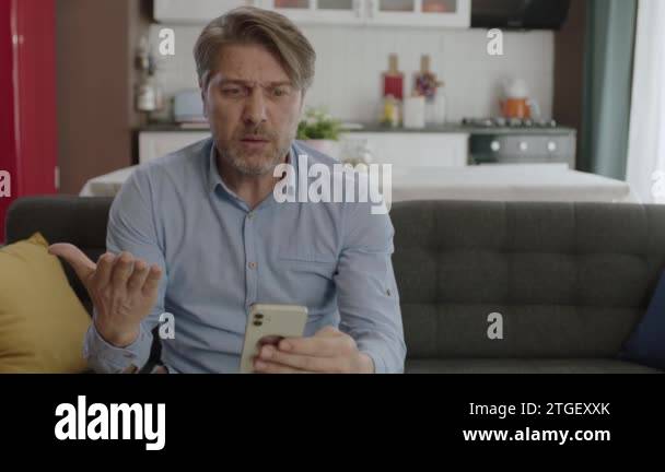 The man gets angry at what he sees on the smartphone.Angry man having ...