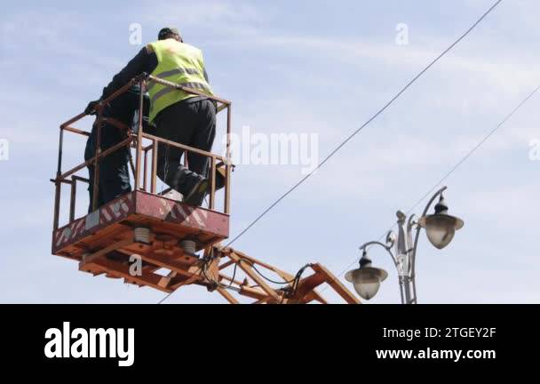 fix light, pole lamp, Municipal worker. Street light repair works are ...