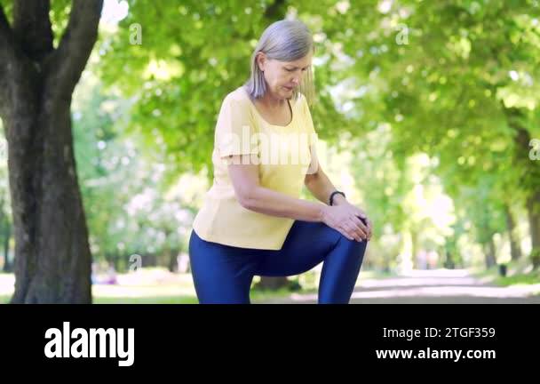 Senior runner with muscle pain. Mature old woman massaging, trauma ...