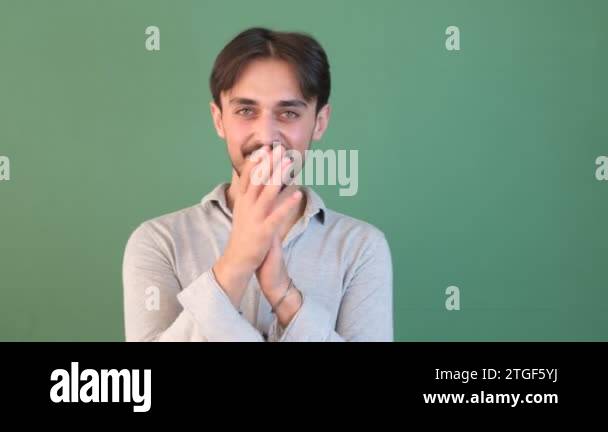 Man gestures happy and rubbing hand green screen, handsome young guy ...