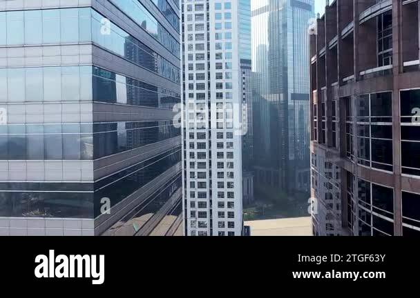 Drone flying between two tall modern skyscrapers towers. Modern ...