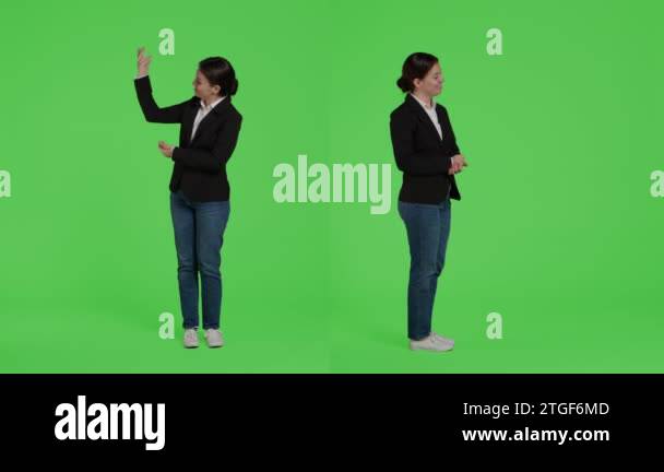 Female manager doing advertisement over full body greenscreen backdrop ...