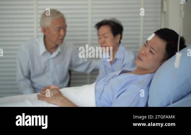 Asian senior parents sad worry about adult son health condition. Man ...