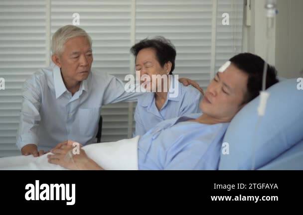 Asian senior parents sad worry about adult son health condition. Man ...