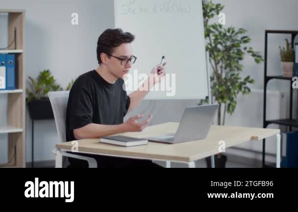 Side job for students. Young clever guy in eyeglasses tutoring online ...