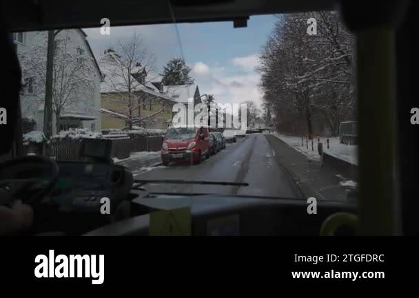 View from a drivers side of a city bus on a snowy street in Munich ...