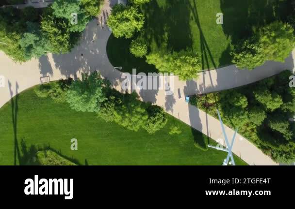 Video of Aerial pan across wavy snake metal path of Pedestrian bridge ...