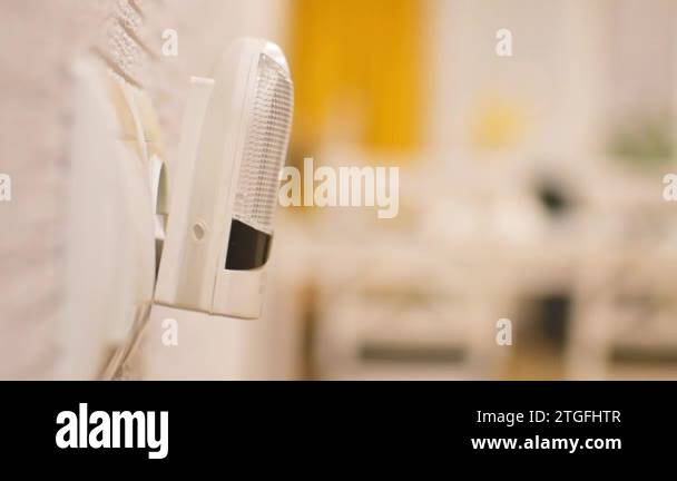 Hand switch off light in kitchen room. Special device connects power ...