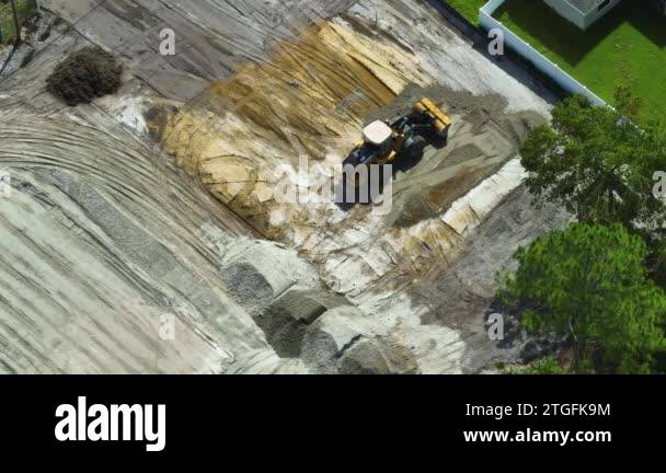 Preparation for construction of a new house. Earth moving tractor ...