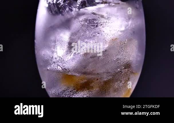 Pieces of ice with frozen air bubbles in the glass. Ice for a drink ...