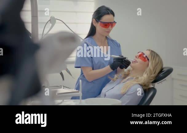 Dentist Working In Office. Young Woman Running With Equipment. In Chair ...