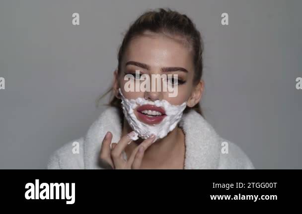 Sexy sensual young woman with foam on the face and a razor blade. Woman ...