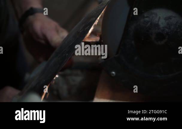 Sharpening a shovel on an electric grinding wheel, Machine sharpening a ...