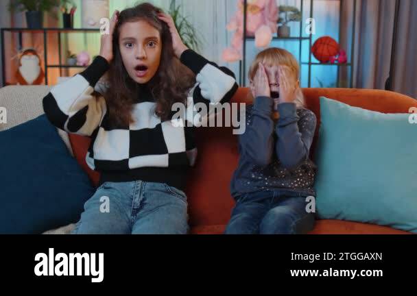 Wow. Excited amazed child and little sister kid girls surprised looking ...