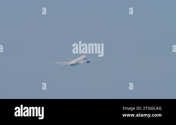 Widebody plane climbing after takeoff, fly away, long shot. Airliner in ...