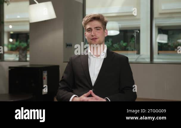 A male office worker communicates on zoom with colleagues at work (look ...
