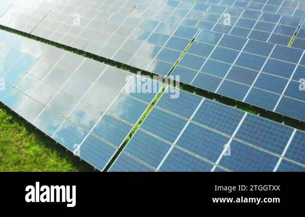 Sun panels reflect white clouds on surface built in rural field. Modern ...