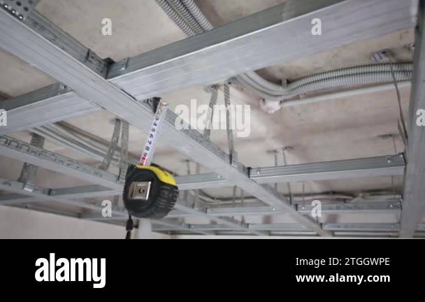 Metal framework for hung ceiling and tape rule in new flat Stock Video ...