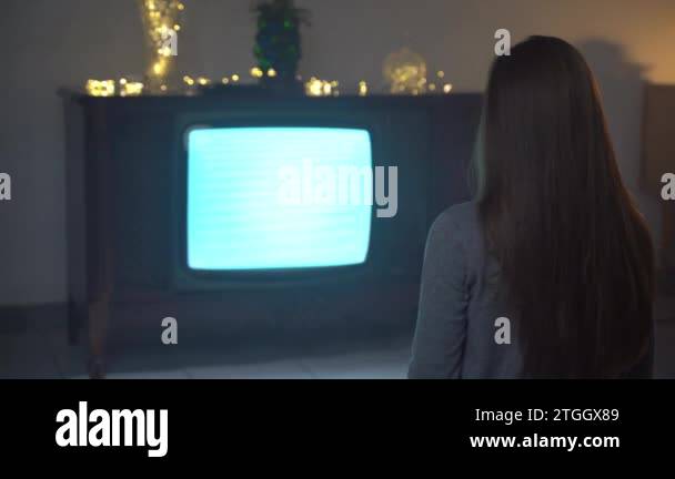 Problem of TV addiction of modern society, woman sitting on the floor ...